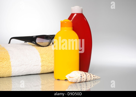 Towel, sunglasses and solar cream Stock Photo - Alamy