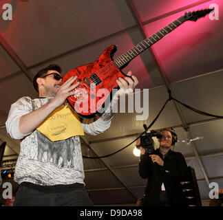 Lead singer Jacob Hoggard of Hedley performs on an outdoor stage before ...