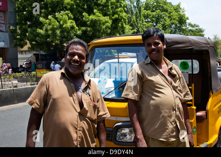 Portrait of smiling auto rickshaw drivers standing on street Trichy ...