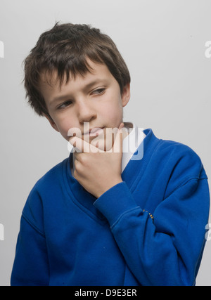 Young boy staring confidently into camera in school uniform Stock Photo ...