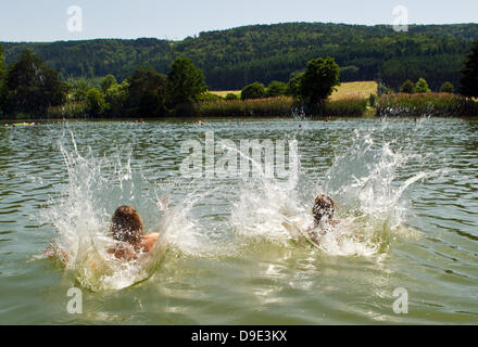 People enjoy the summer weather at Baggersee Lake in Pluederhausen ...