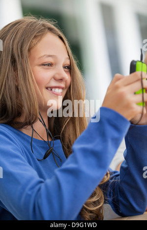 Smiling girl on cell phone Stock Photo - Alamy