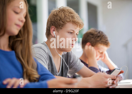 Students using electronic gadget in a classroom Stock Photo - Alamy