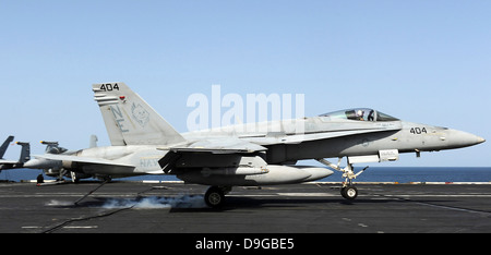 An F/A-18C Hornet makes an arrested landing aboard USS Nimitz (CVN 68 ...