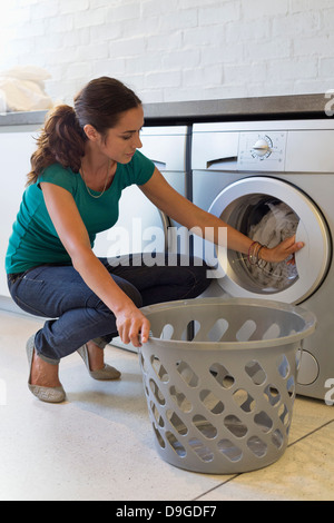 Woman doing laundry at home Stock Photo - Alamy