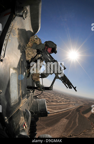 A US Army machine gun crew sets up an overwatch position during a foot ...