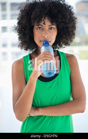 Portrait of woman taking break from jogging Stock Photo - Alamy