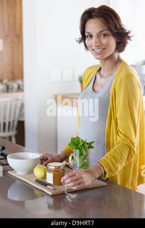 smiling young woman with bowl of honey on white background Stock Photo ...