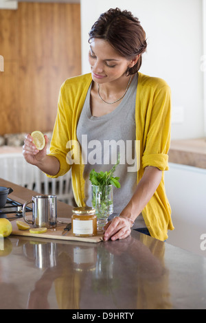 smiling young woman with bowl of honey on white background Stock Photo ...