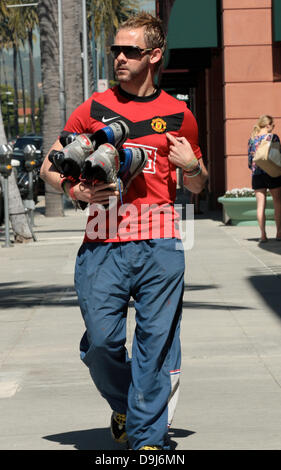 Dominic Monaghan proudly wears his Manchester United shirts as he takes ...