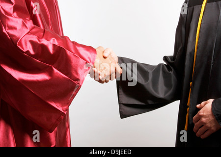 Shaking hands, graduation and certificate for college student with ...