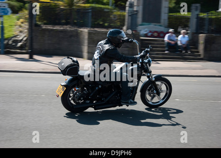 Man on Harley Davidson riding through US small town Stock Photo - Alamy