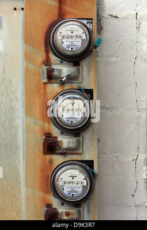 Electric meter on white brick wall. Energy measuring device Stock Photo ...