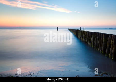 Sunset on the beach with breakwater, long time exposure Stock Photo - Alamy
