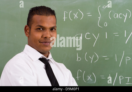 Young male math teacher in classroom Stock Photo - Alamy