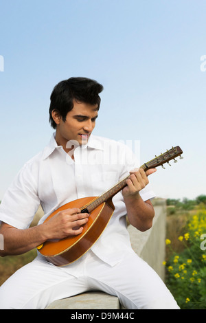 Man playing a mandolin and smiling Stock Photo - Alamy