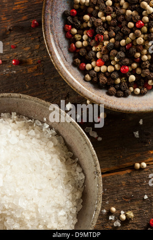 Sea salt and red hot pepper with bay leaf and colorful peppercorns on ...