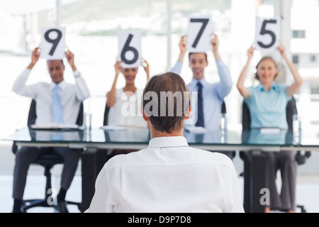 Happy Panel Judges Sitting In Front Of Red Curtain Showing 10 Score ...