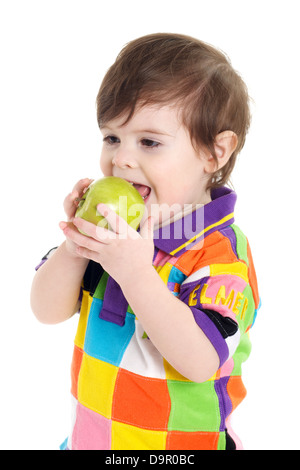 Cute toddler boy eating an apple in apple tree orchard in summer day ...