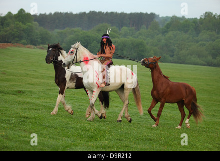 A Native American Indian boy riding bareback on a horse on the prairie ...