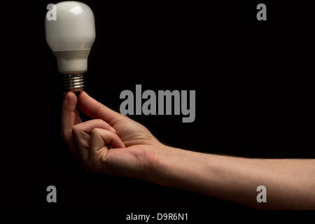 Man holding economic bulb in his fingertips Stock Photo - Alamy