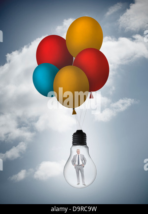 Businessman inside light bulb Stock Photo - Alamy