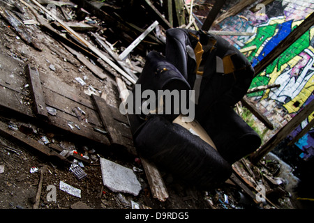 Crack den, an old armchair sits in the middle of a collapsing building ...