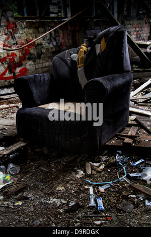 Crack den, an old armchair sits in the middle of a collapsing building ...