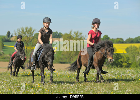 Girls riding a shetland pony Stock Photo - Alamy