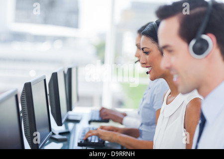 Customer service agents working on computer, helping people online and ...