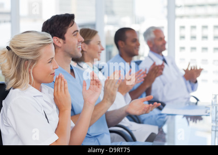 Medical team clapping hands Stock Photo - Alamy