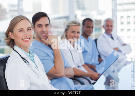 Medical team sitting in row Stock Photo - Alamy