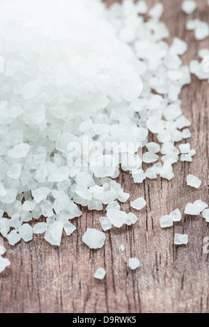 close up of white salt heap on wooden table Stock Photo - Alamy