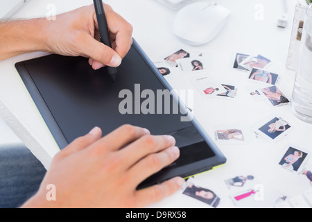 Female hands using graphics tablet and glass icons fly in air. Mixed ...