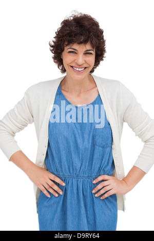 Smiling brunette woman placing hands on hips Stock Photo - Alamy