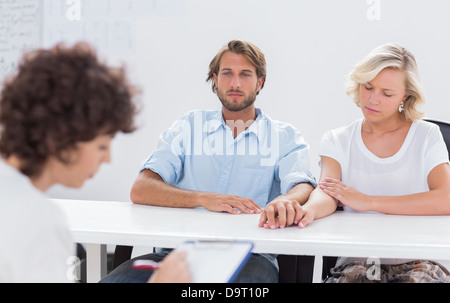 Young hispanic man psychologist writing on document holding brain ...