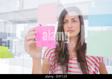 Caucasian woman checking her sticky note Stock Photo - Alamy