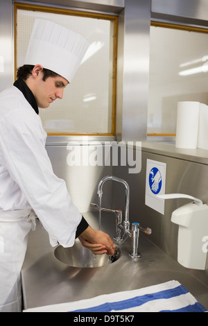 Concentrated chef washing hands Stock Photo - Alamy