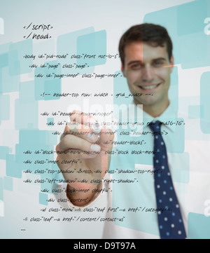 Smiling businessman writing sql language on white background Stock ...