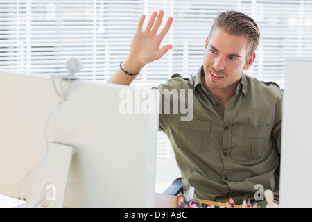Creative business employee waving in a modern office Stock Photo - Alamy