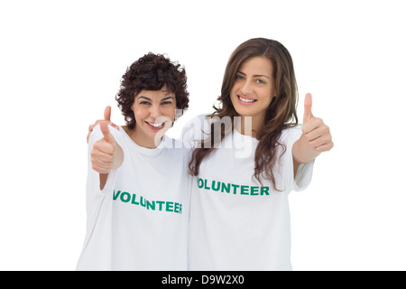 Two young volunteers woman smiling happy working at charity center ...