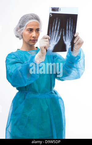 Asian female medical professional examining anatomical brain model ...
