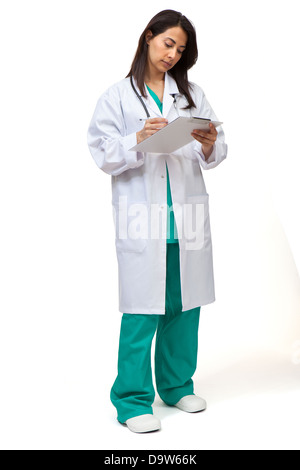 Female doctor taking notes on clipboard in medical office Stock Photo ...