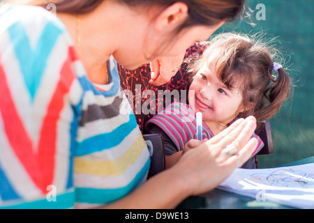 2 and a half year old girl with Down's syndrome with her mother Stock ...