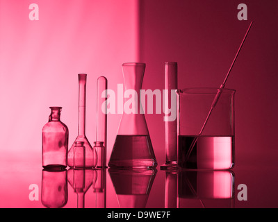 Different laboratory glassware with light blue liquid isolated on white ...