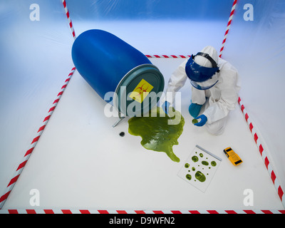 upper view of female specialist collecting samples from a green puddle ...