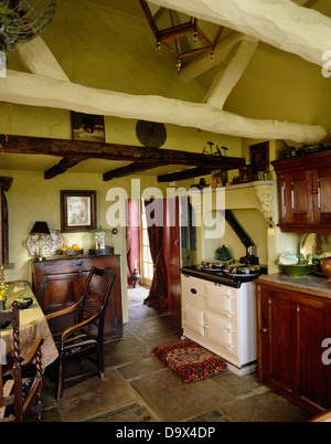 Cream Aga in a country kitchen with an exposed brick wall and rustic ...