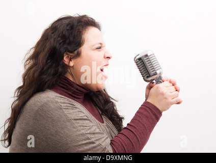 Woman yelling into microphone Stock Photo - Alamy