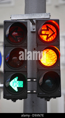 Traffic light with green arrow left and right turn signal against blue ...
