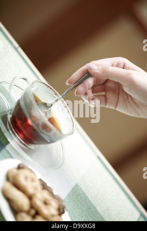 Human hands making tea Stock Photo - Alamy